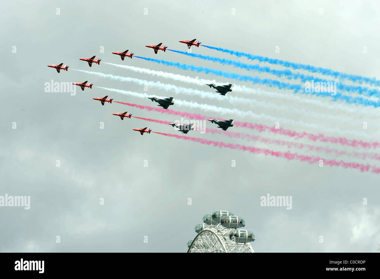 The Red Arrows make a fly-past over the Thames on the 90th anniversary ...