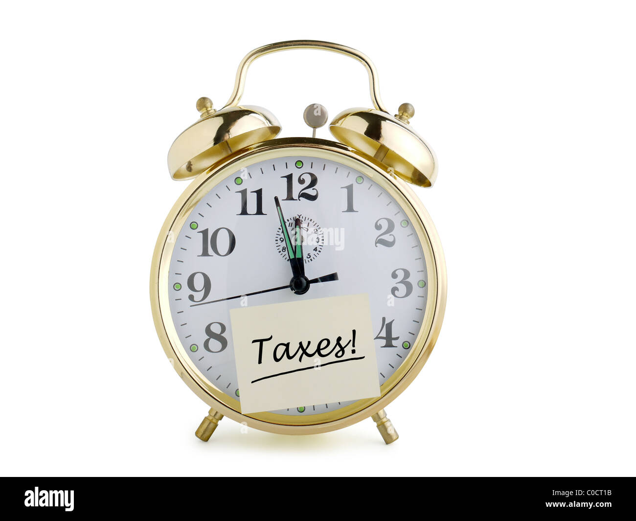 Yellow post-it note as tax reminder affixed to alarm clock shot over ...