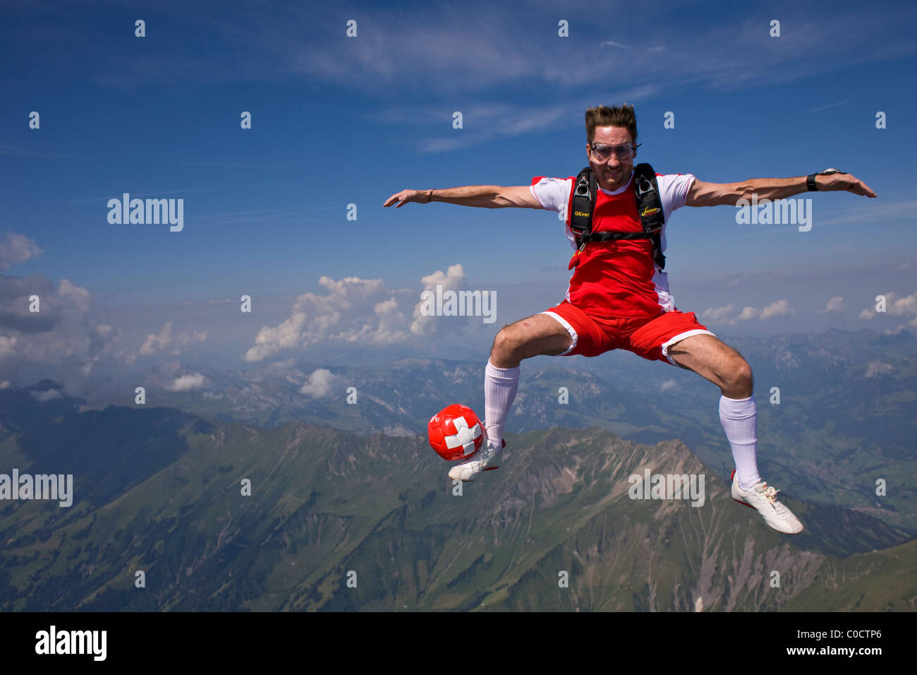 Man is playing soccer football in freefall over mountains Stock Photo ...