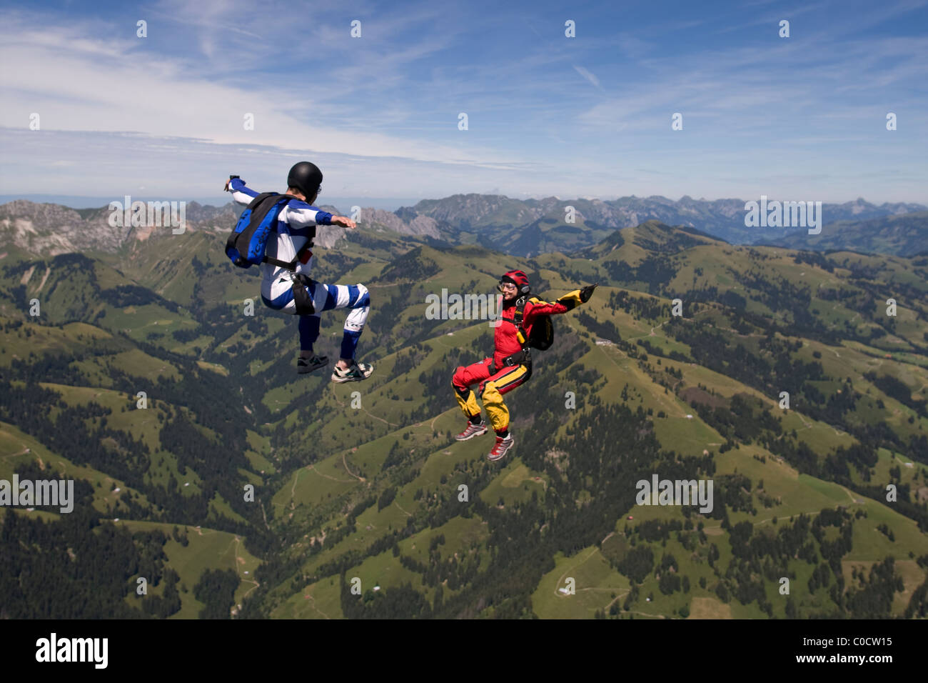 Skydivers are flying head up within a team in the sit fly position over ...