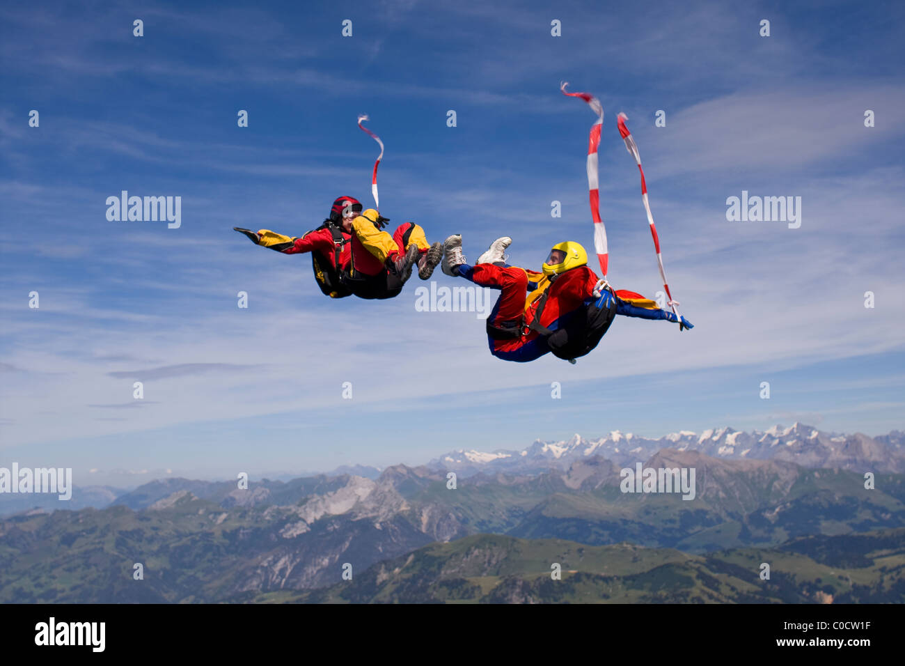 Skydivers are flying head up within a team in the sit fly position over ...