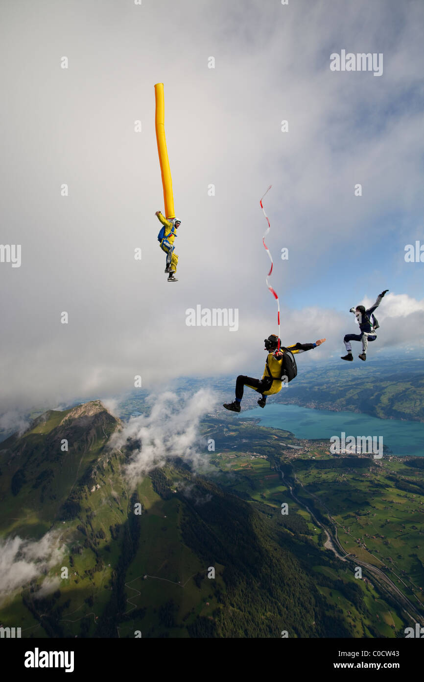 Skydiver with air tubes is flying around the clouds. The Freeflyers are ...