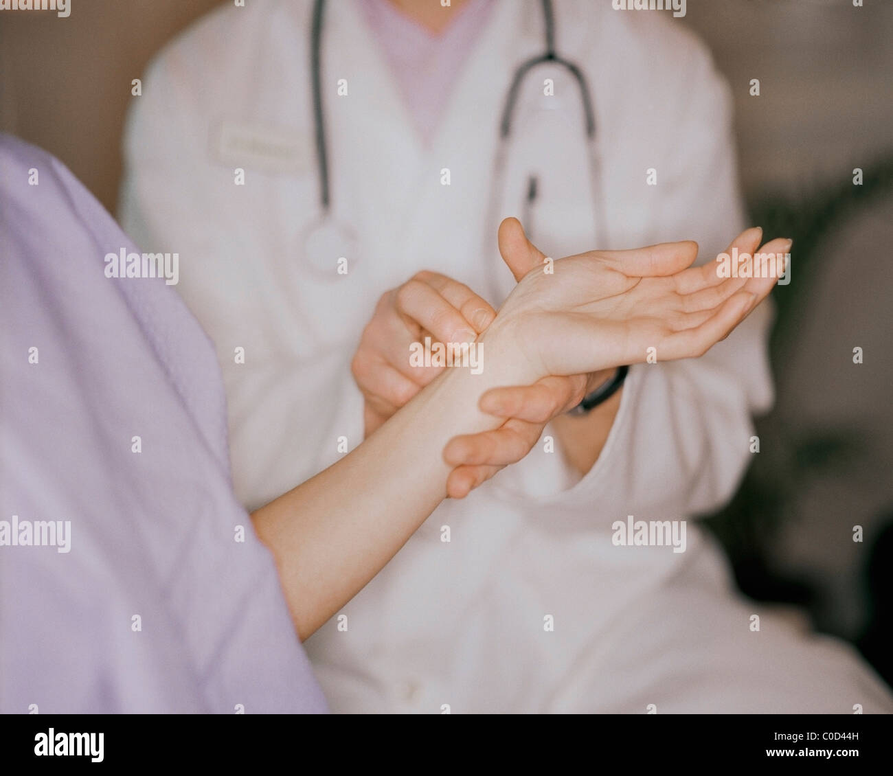 Doctor taking female patient's pulse Stock Photo - Alamy