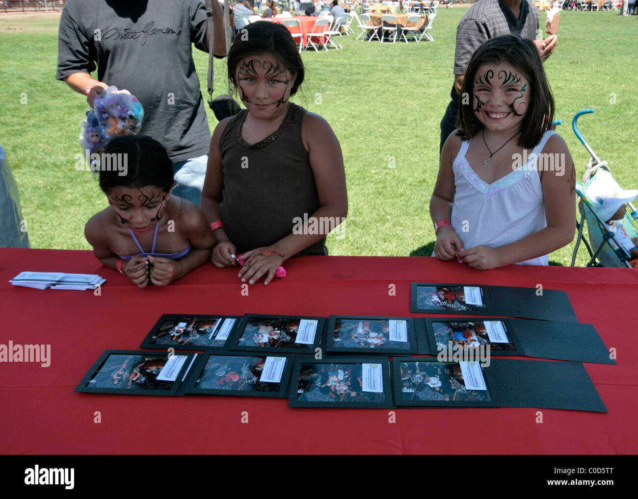 Children at an event picking up their photo booth instant photos Stock ...