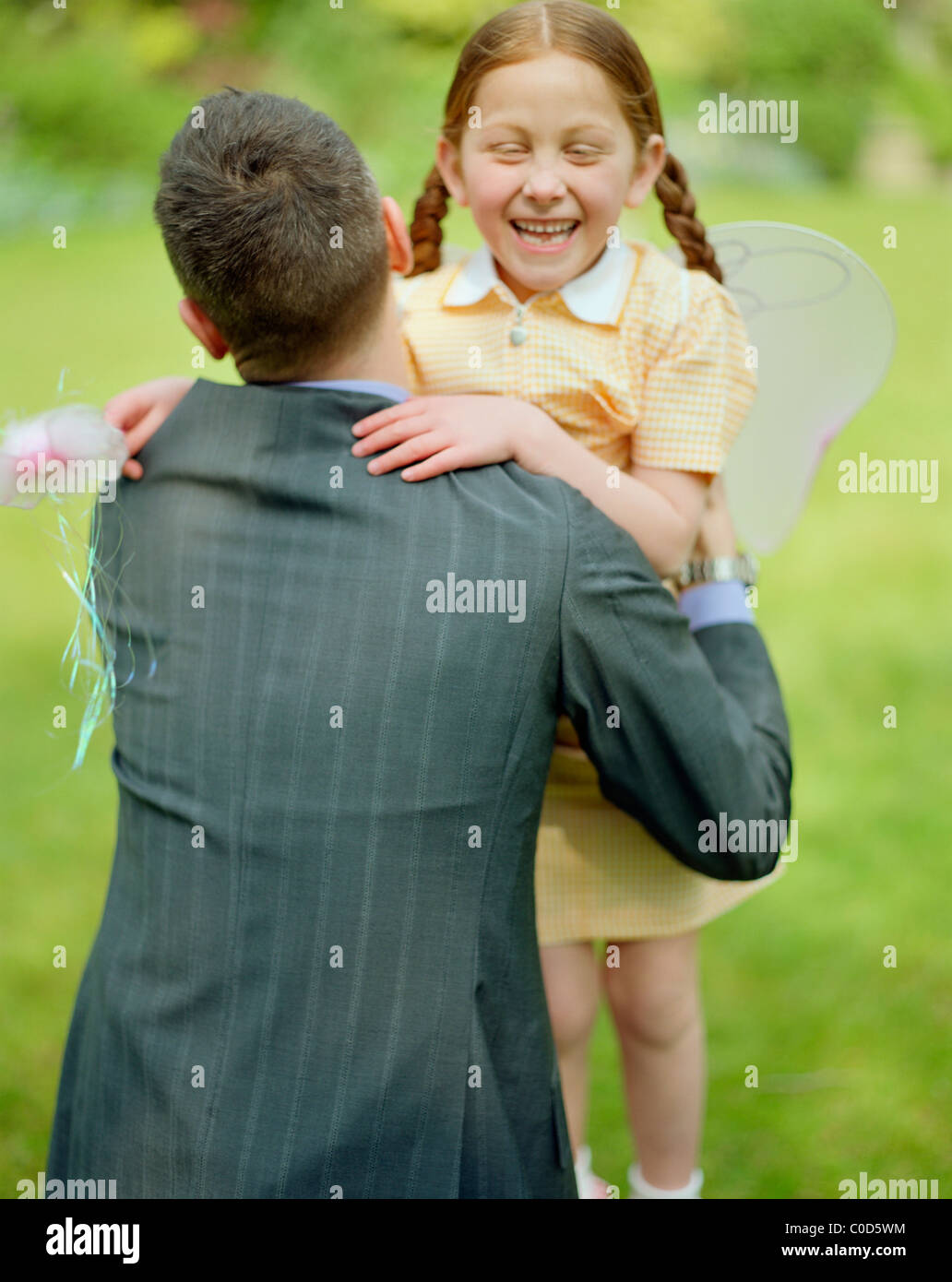 Father holding daughter wearing fairy wings Stock Photo - Alamy