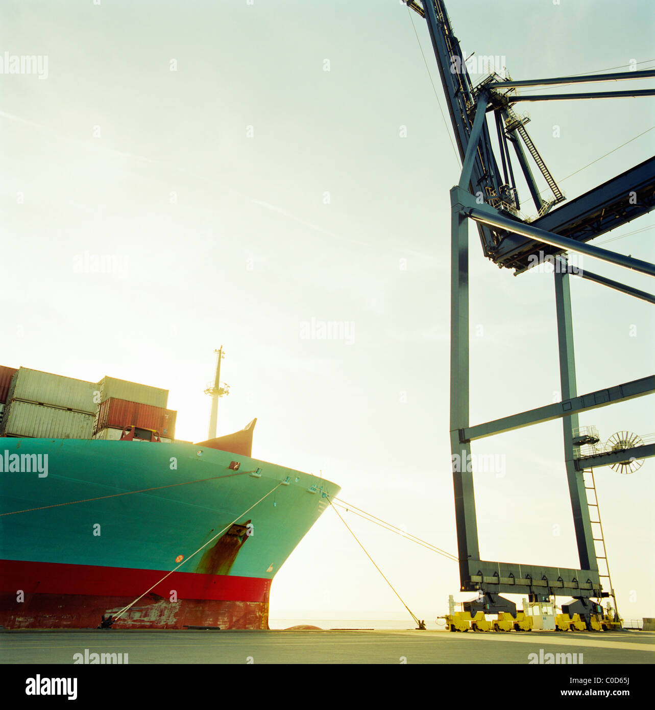 A large freight ship loaded with containers at the quay side. A crane ... A large freight ship loaded with containers at the quay side. A crane ...