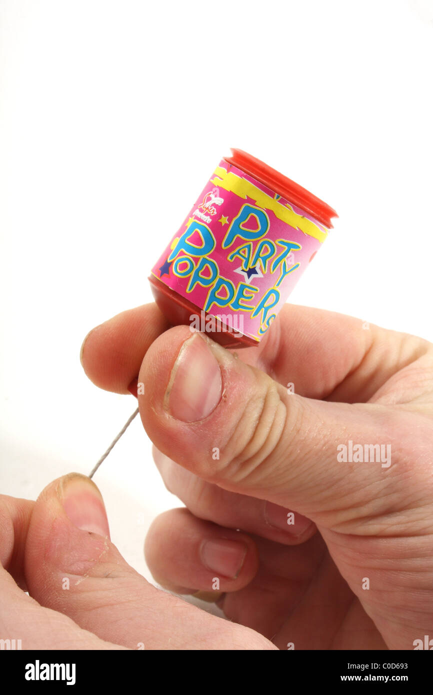 A white Caucasian male poised and ready to pull a red party popper, on ...