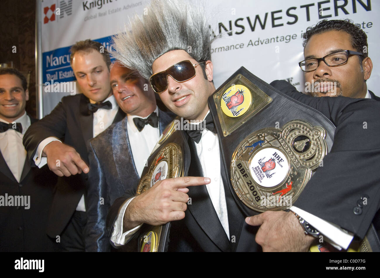 Promoter David Goldberg, second from right, shows off the winners belt ...