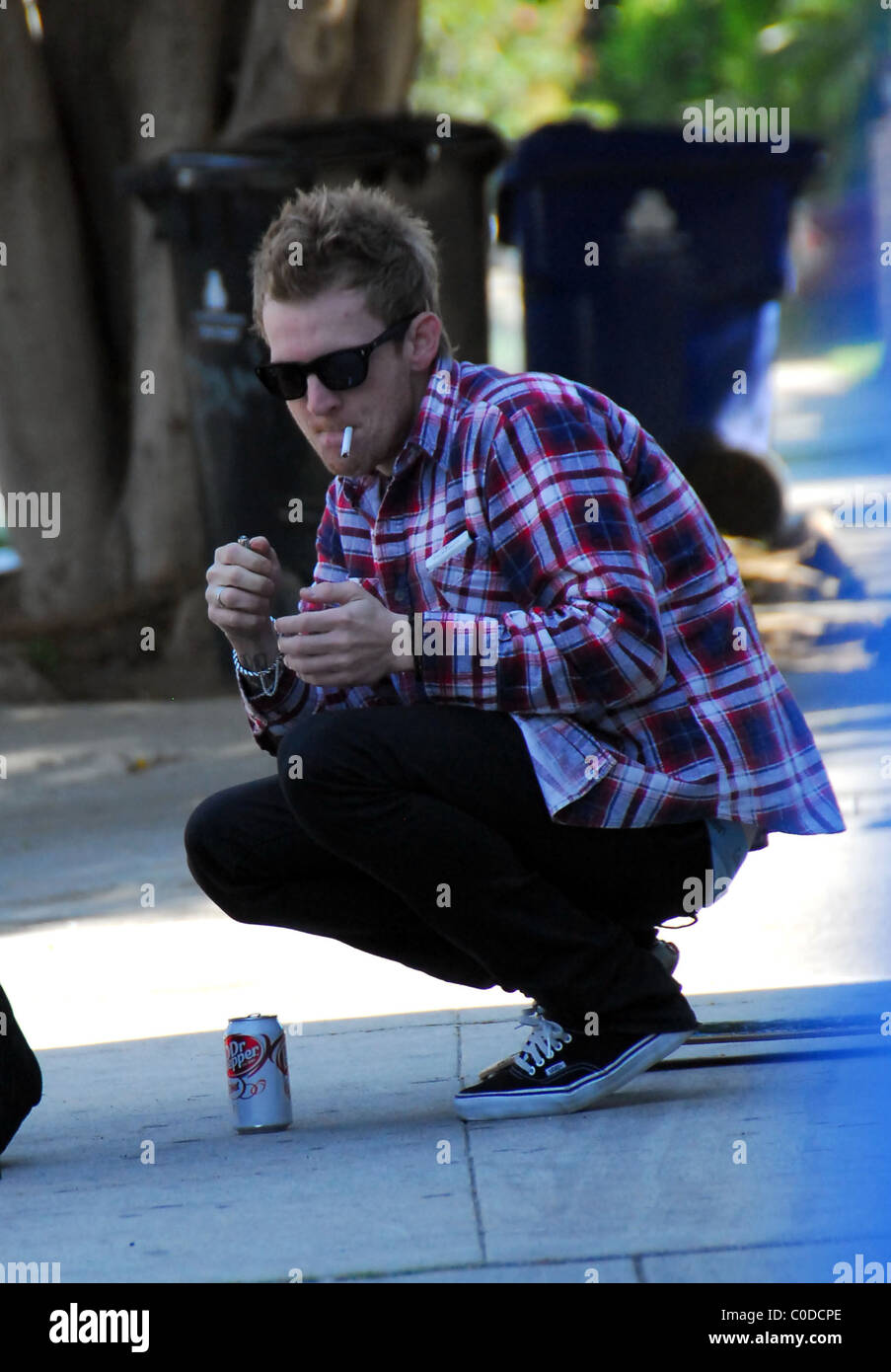 Josh Madden lights a cigarette as he hangs out in front of the DCMA ...