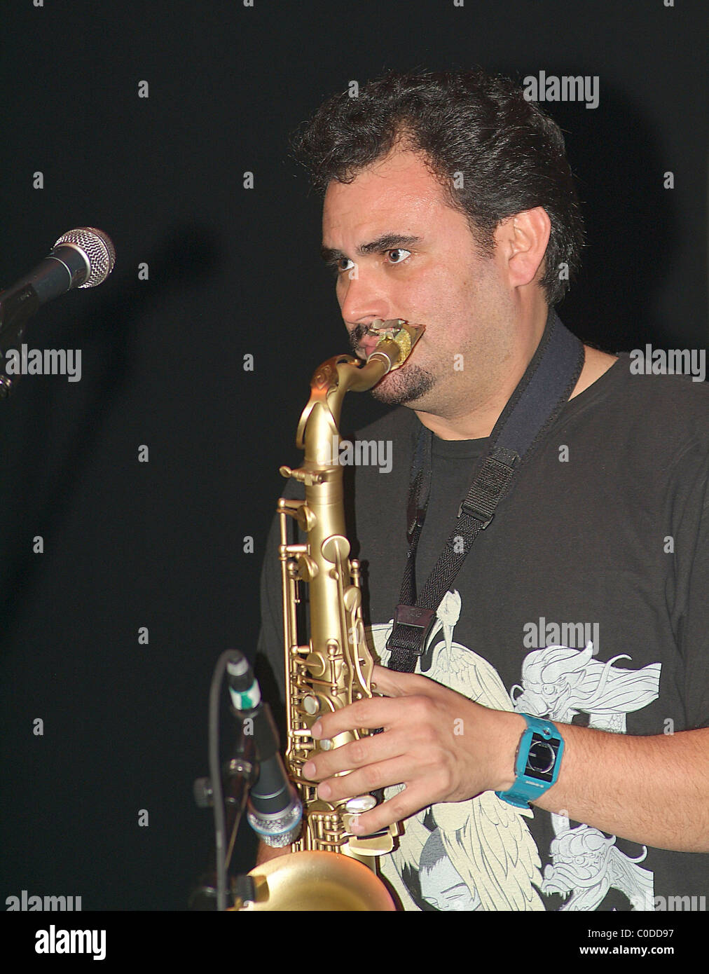 Member of Ozomatli performing at the 50th Grammy celebration concert ...