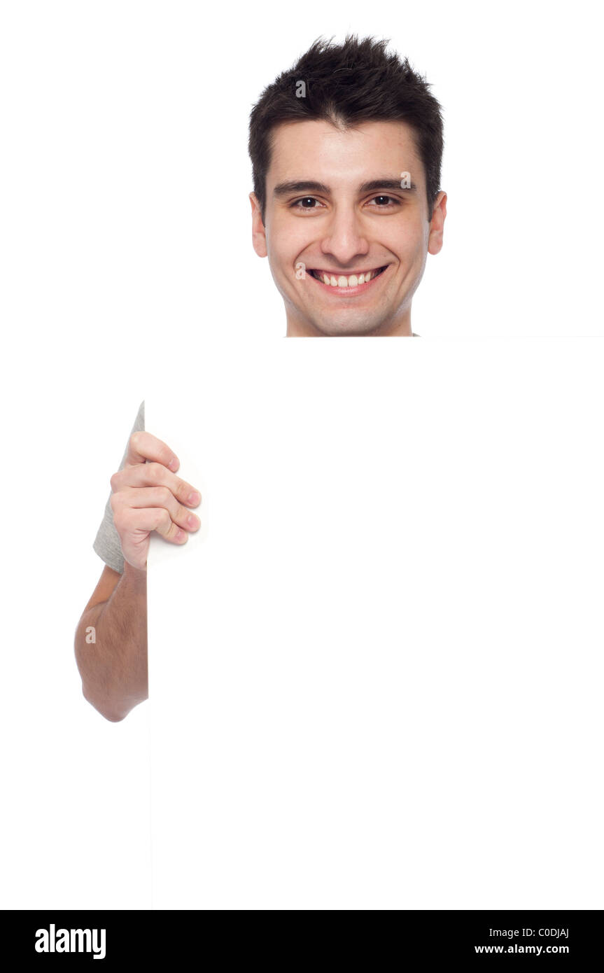 handsome young man displaying a banner ad isolated on white background ...