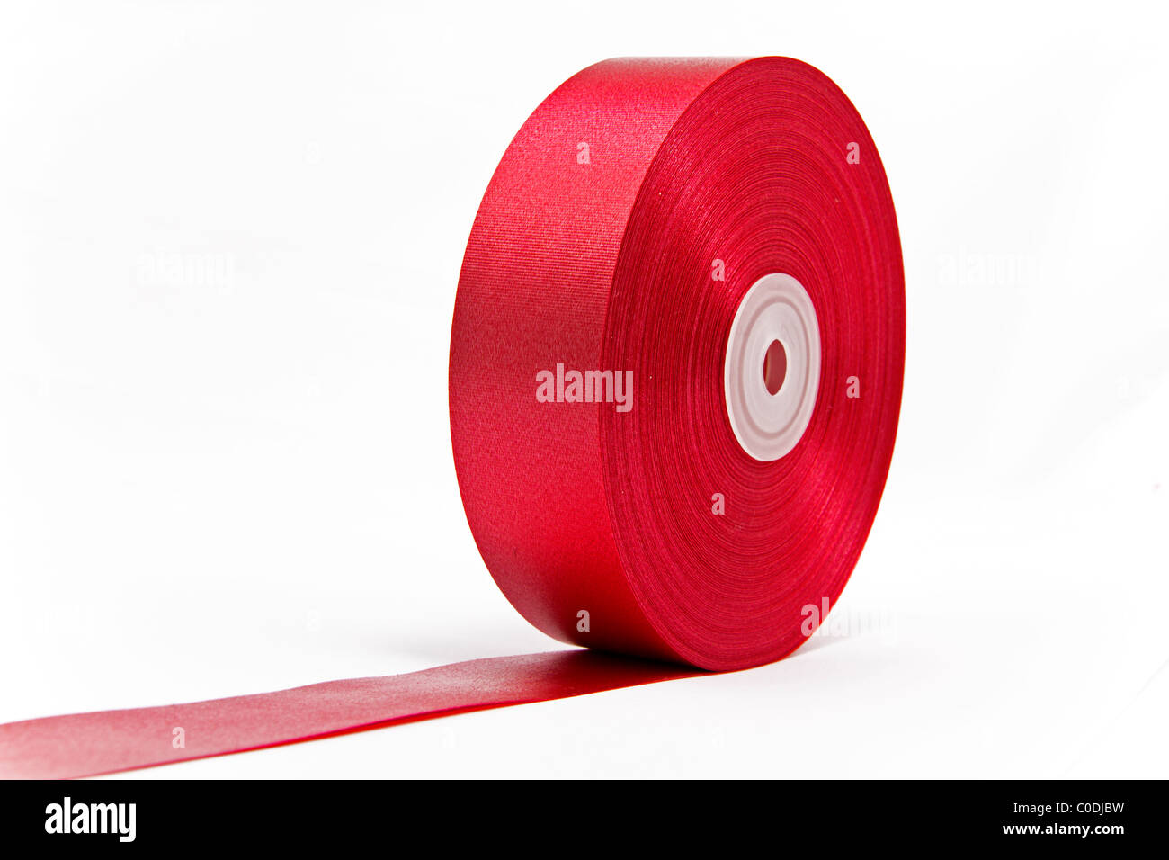 A roll of shiny red ribbon unrolled like a giant red carpet Stock Photo ...