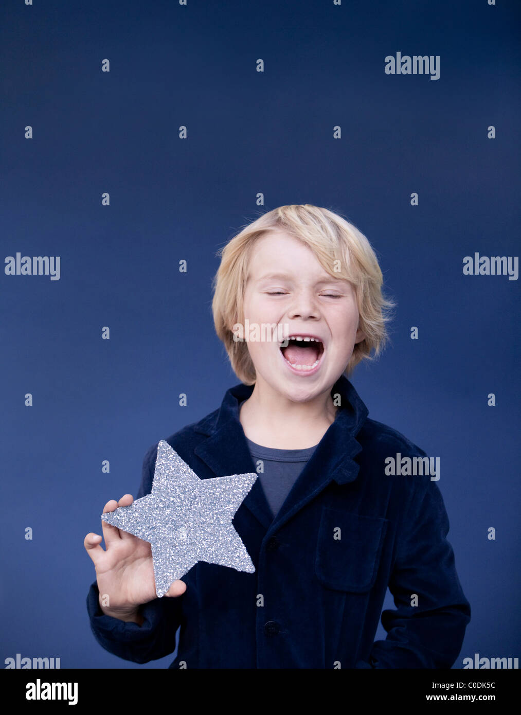 Little boy holding silver star Stock Photo - Alamy