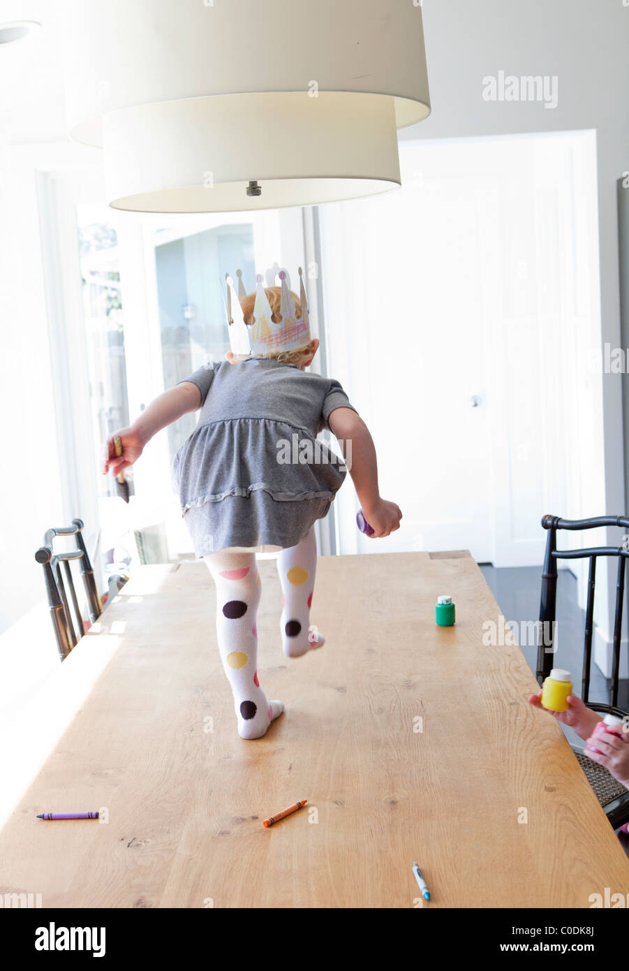 Little girl playing on wooden table Stock Photo - Alamy