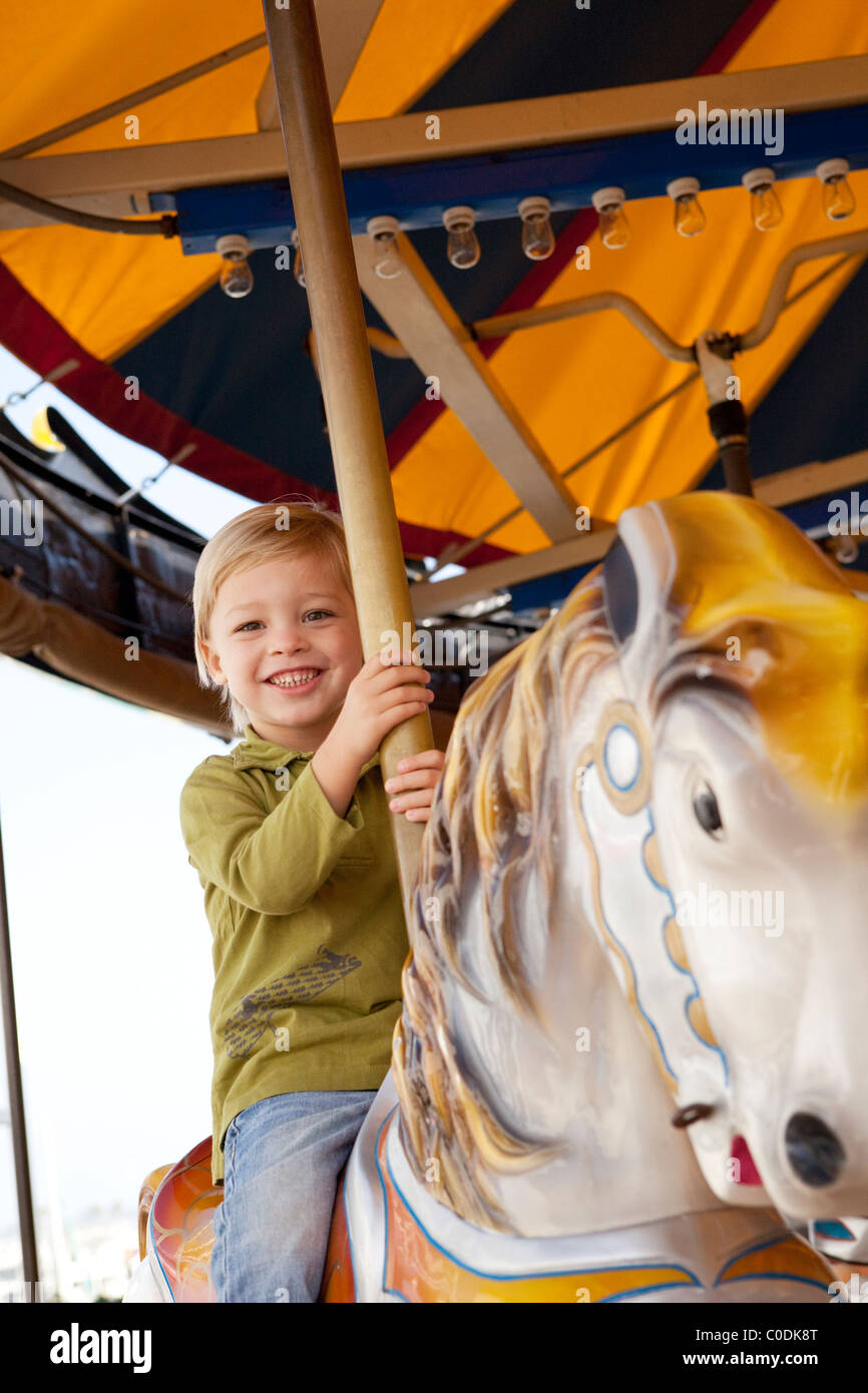 Little boy on carousel Stock Photo - Alamy