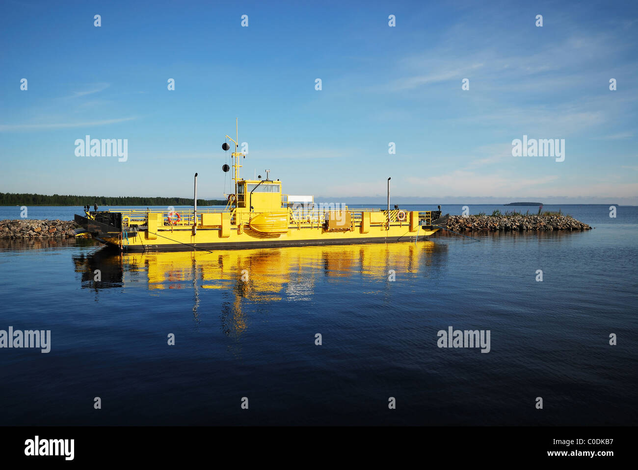 Yellow ferry is sailing in the quiet lake. There are a lot of blue ...
