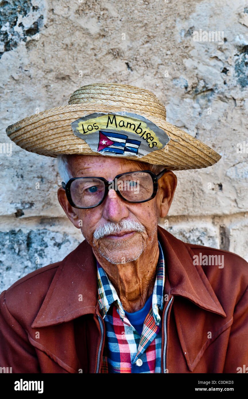 Cuban man sitting in the doorway to his Colonial home. Habana Vieja ...