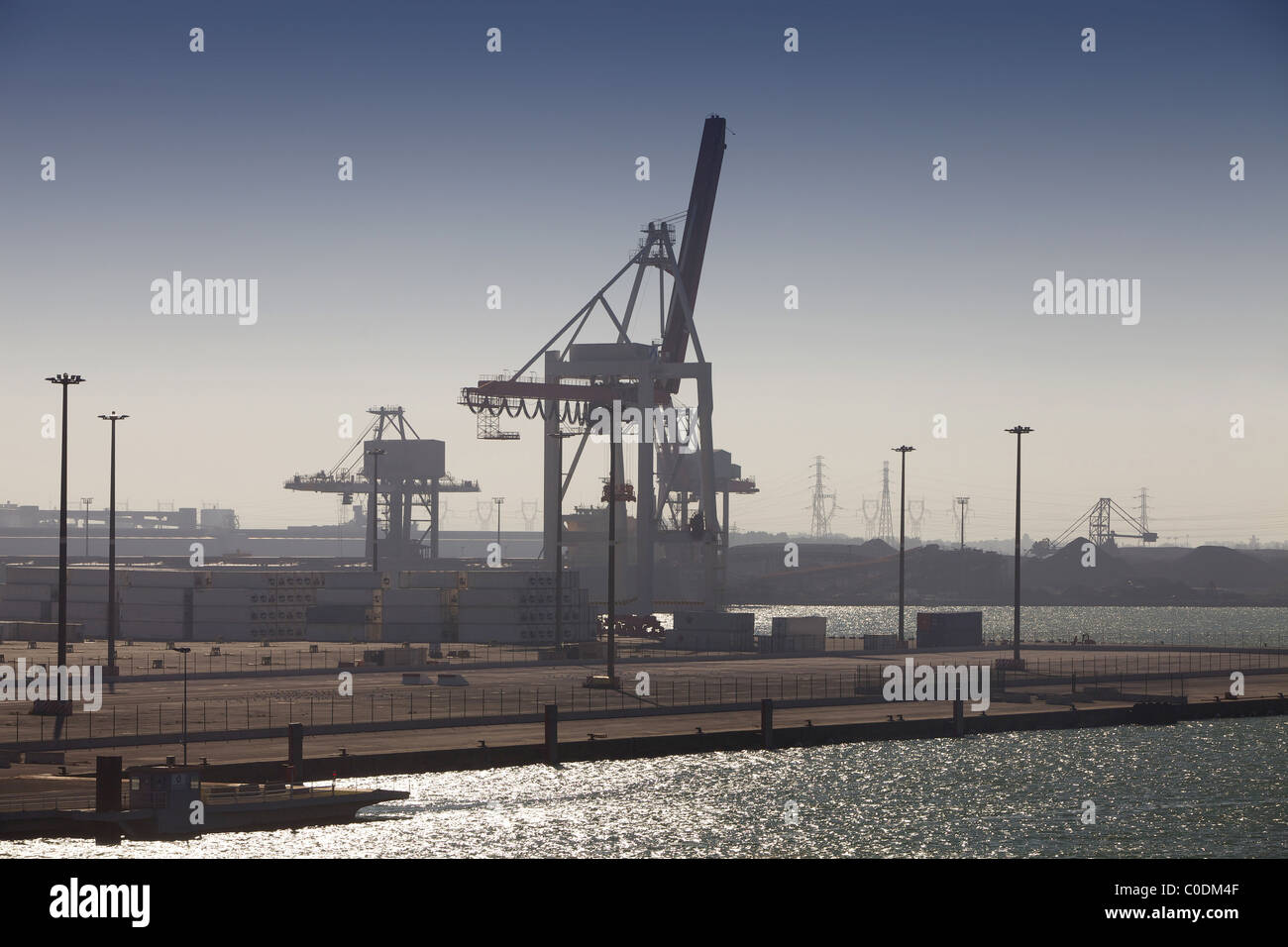 Cranes and containers at a modern dock terminal, with older heavy ...