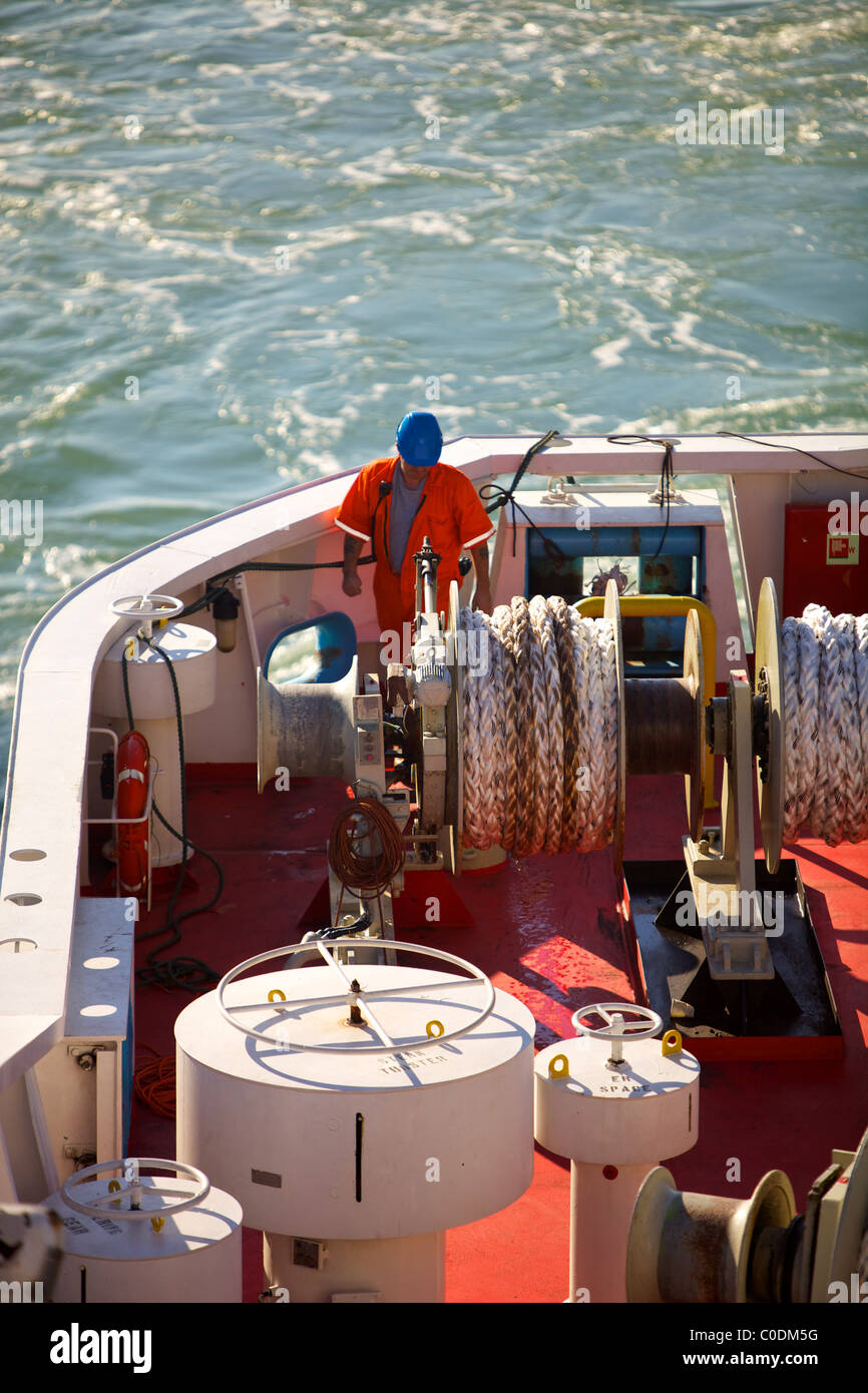 A deckhand on a North Sea Ferry at work securing cables Stock Photo - Alamy