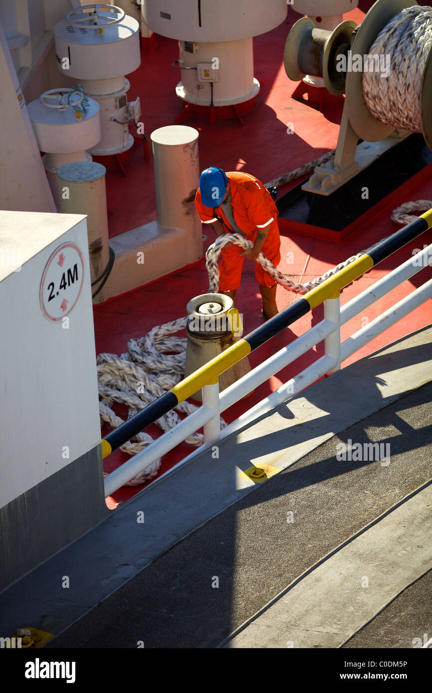 A deckhand on a North Sea ferry arranging anchor ropes Stock Photo - Alamy