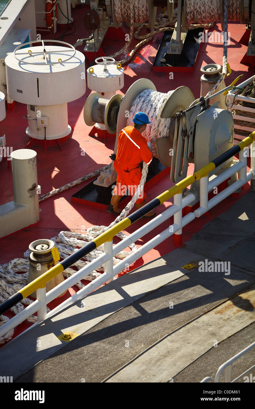 A deckhand on a North Sea ferry arranging anchor ropes Stock Photo - Alamy