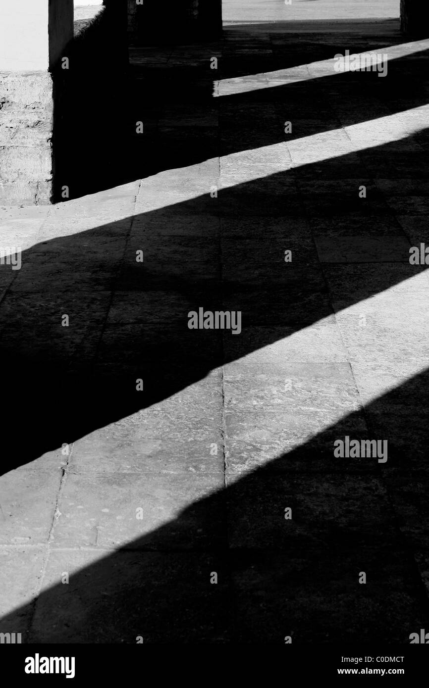 Column shadows on granite pavement Stock Photo - Alamy