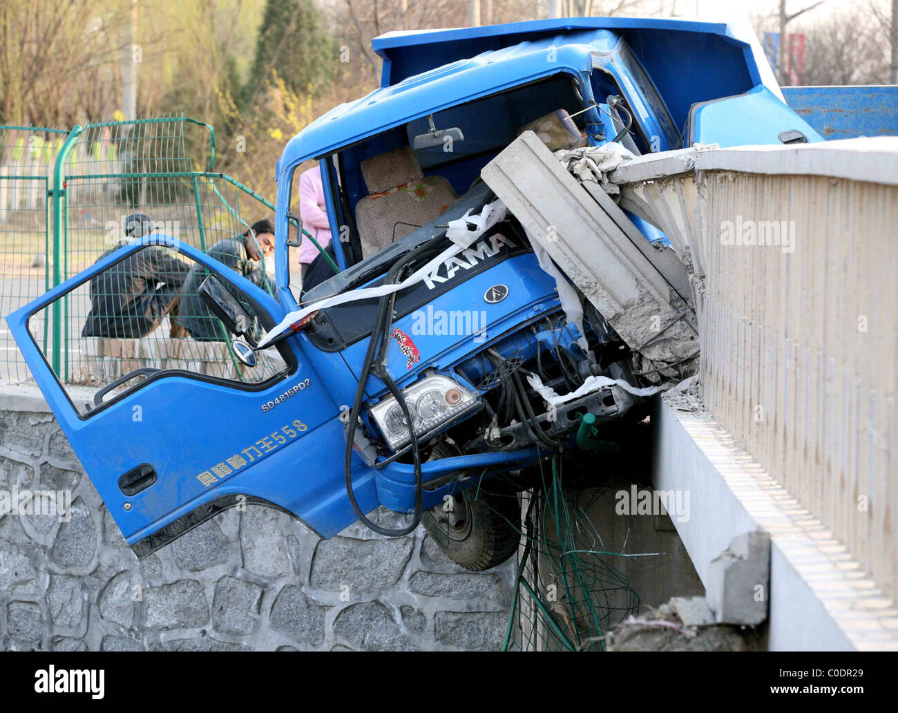BRIDGE ACCIDENT This truck hangs precautiously onto the edge of a ...
