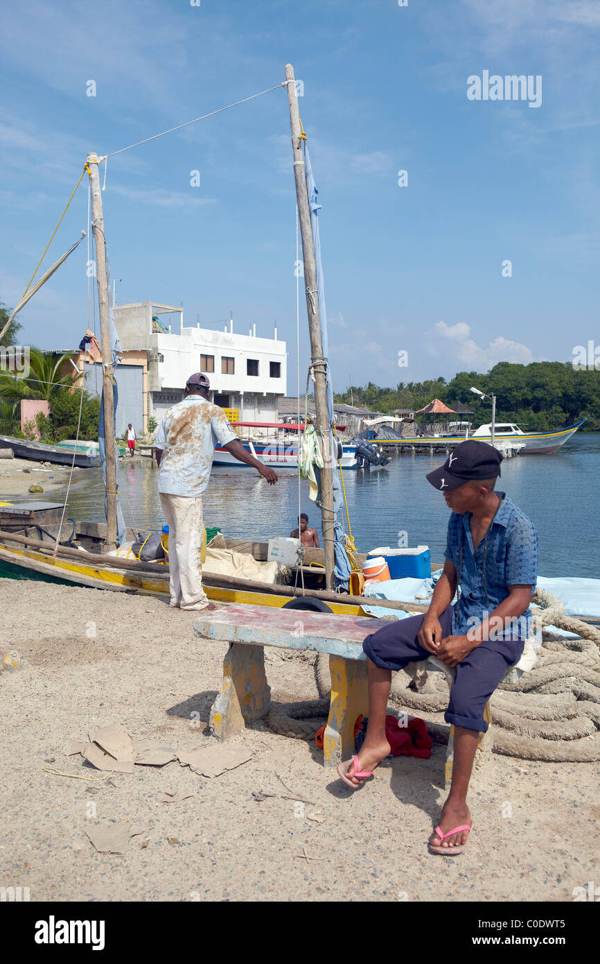 young black Colombian boy sitting on wooden bench Stock Photo - Alamy