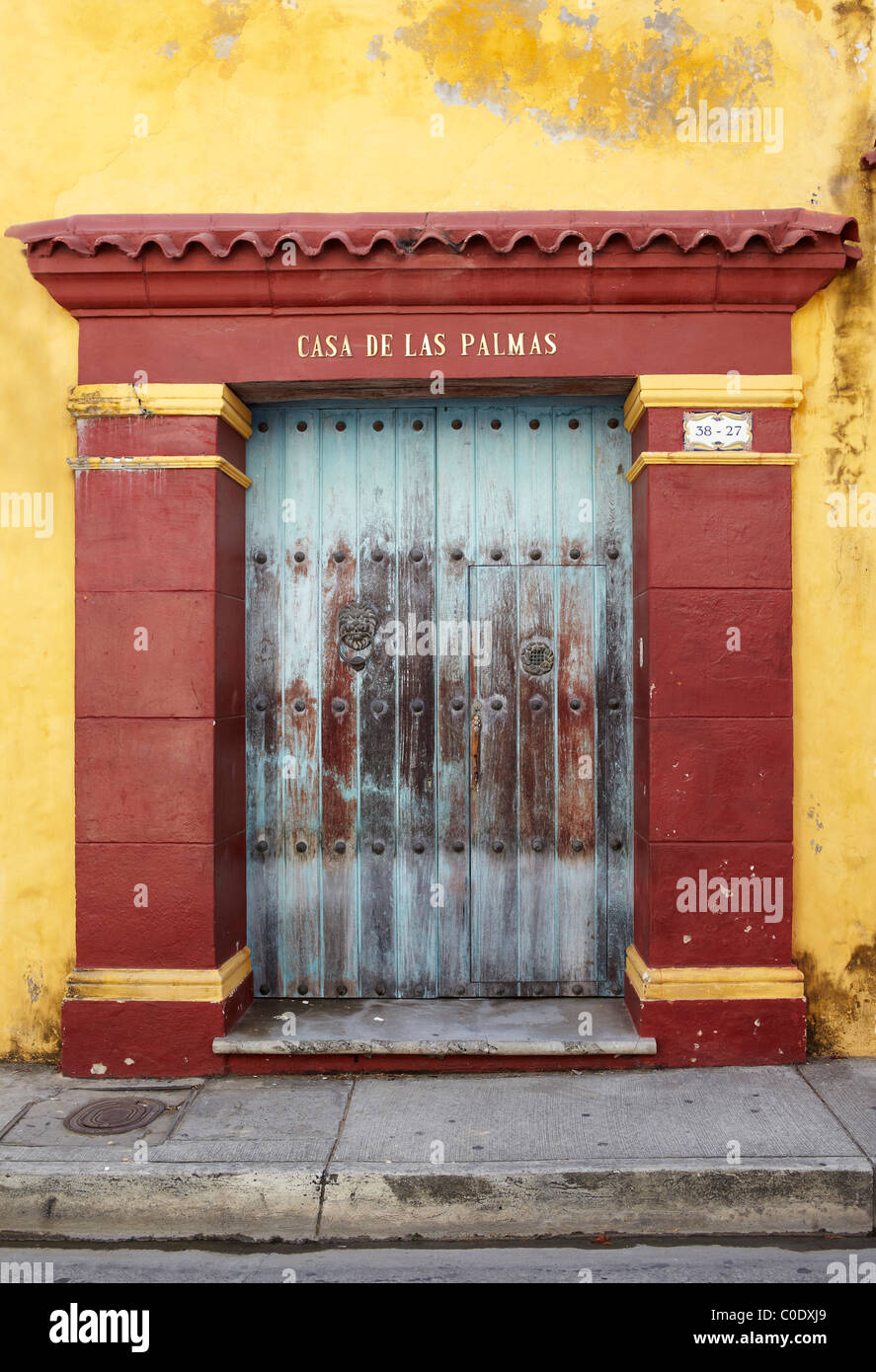 wooden front door on yellow colonial building Stock Photo - Alamy