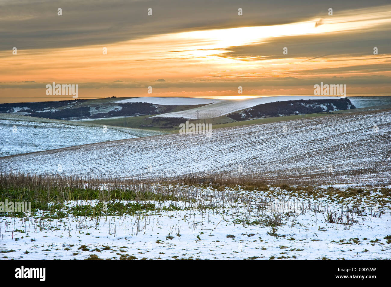 English countryside Winter snow landscape over fields with glowing ...