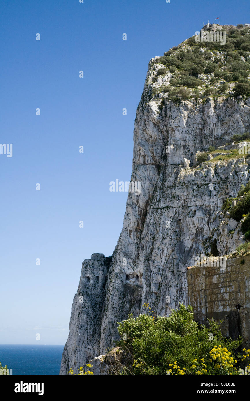 Cliff on the side of the ridge of the Rock of Gibraltar, and peak tops ...