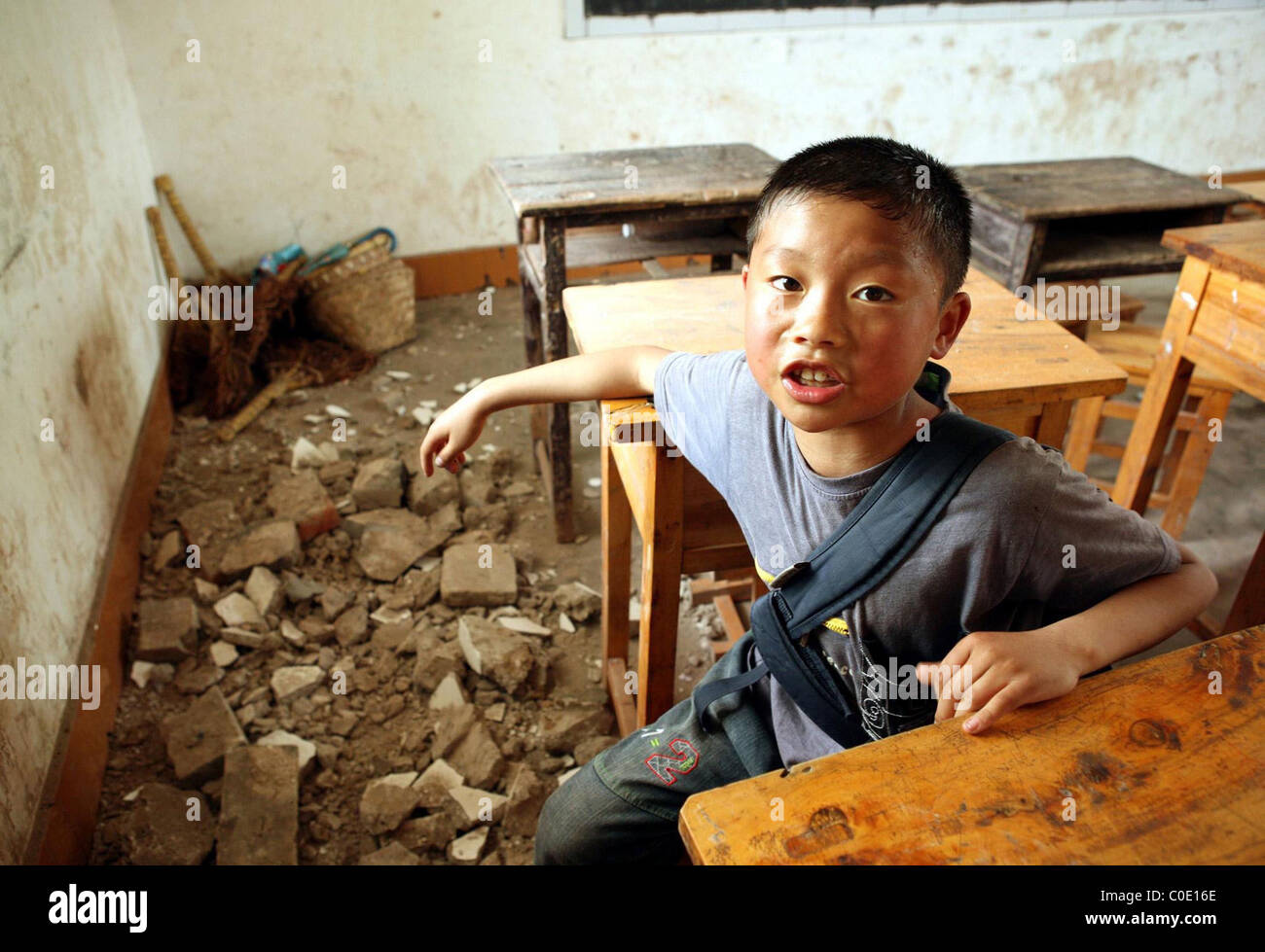 A student shows the damage to his classroom after China's worst ...