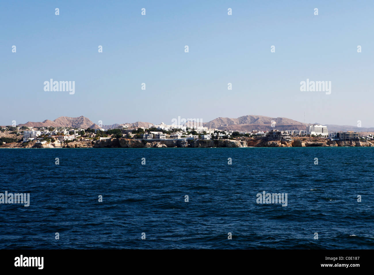 Looking over the blue waters of the Gulf of Oman to the city of Muscat ...