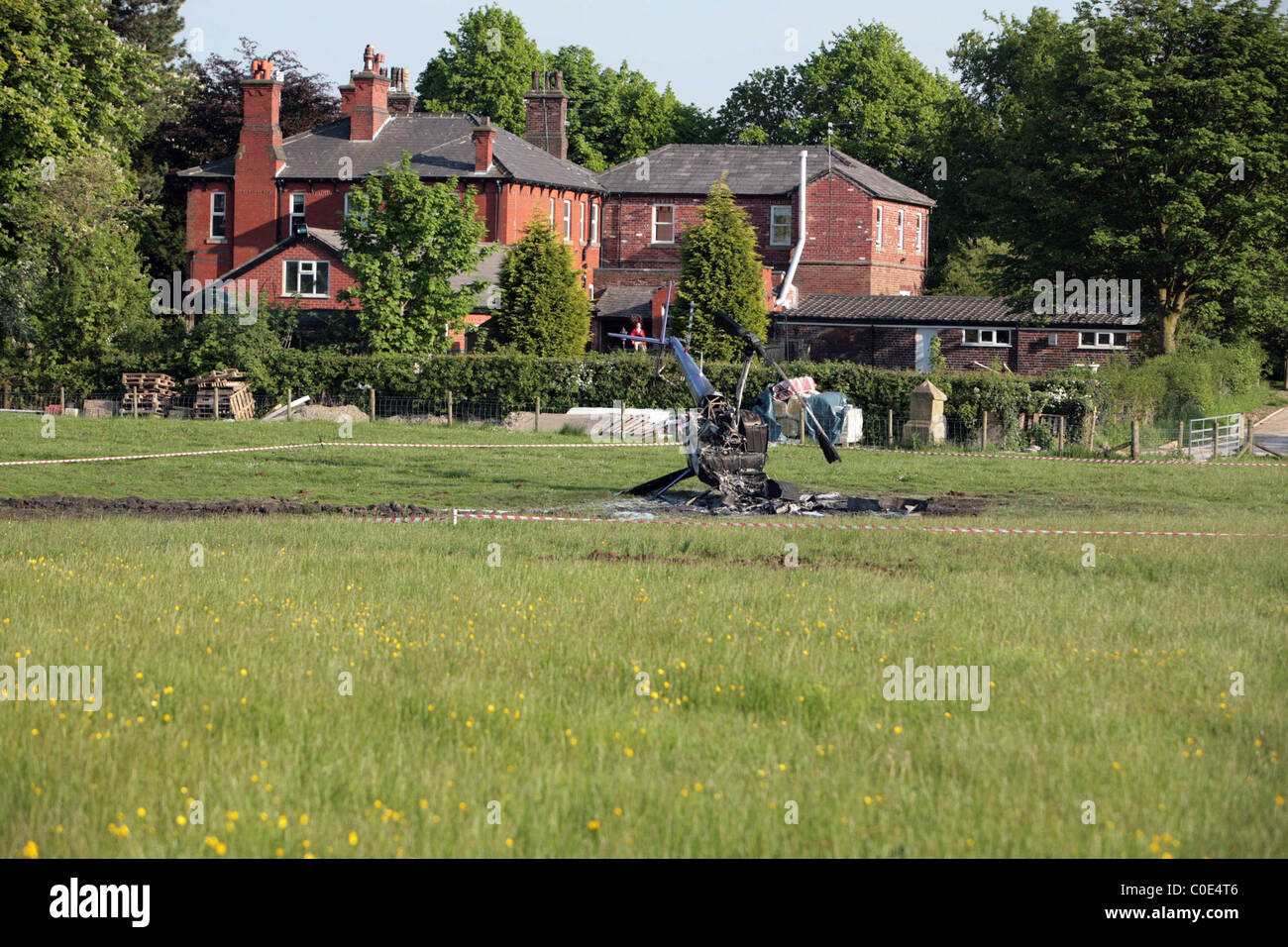 The chard remains of a burnt out helicopter after it crash landed in ...