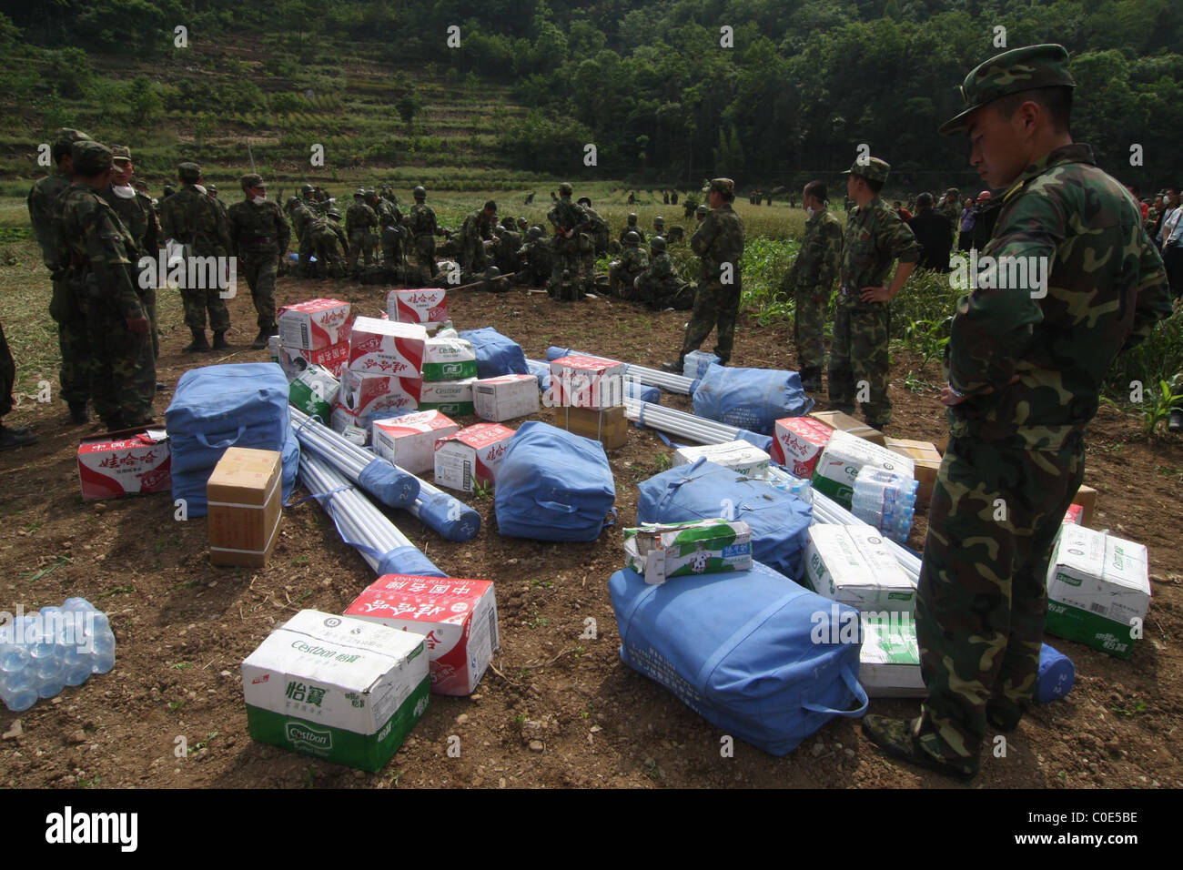 PLA soldiers carry disaster-relief goods dropped by helicopter in ...