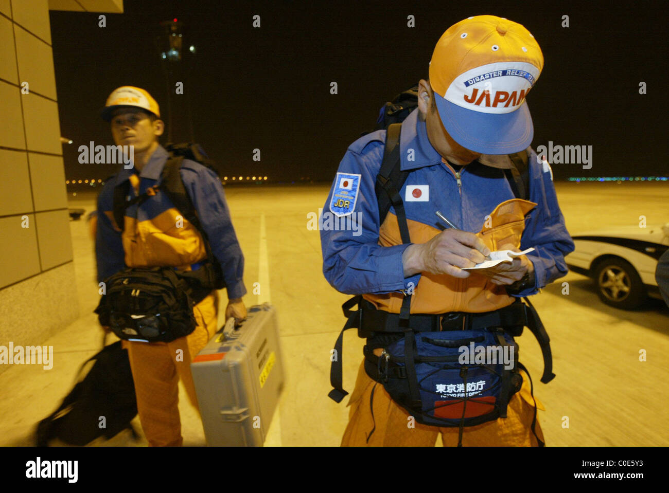 A group of rescue professionals sent by the Japanese government arrive ...