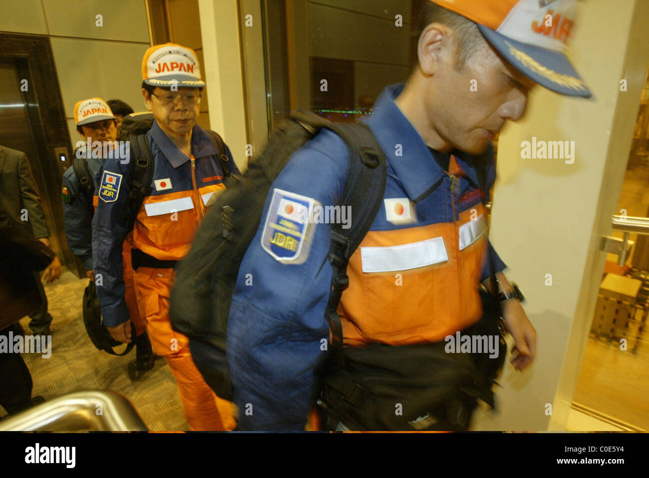 A group of rescue professionals sent by the Japanese government arrive ...