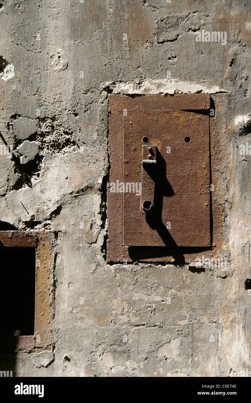 old rusty steel door hatch on wall on derelict property Stock Photo - Alamy