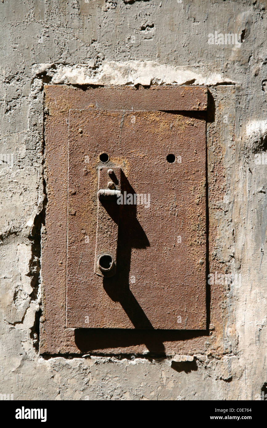 old rusty steel door hatch on wall on derelict property Stock Photo - Alamy
