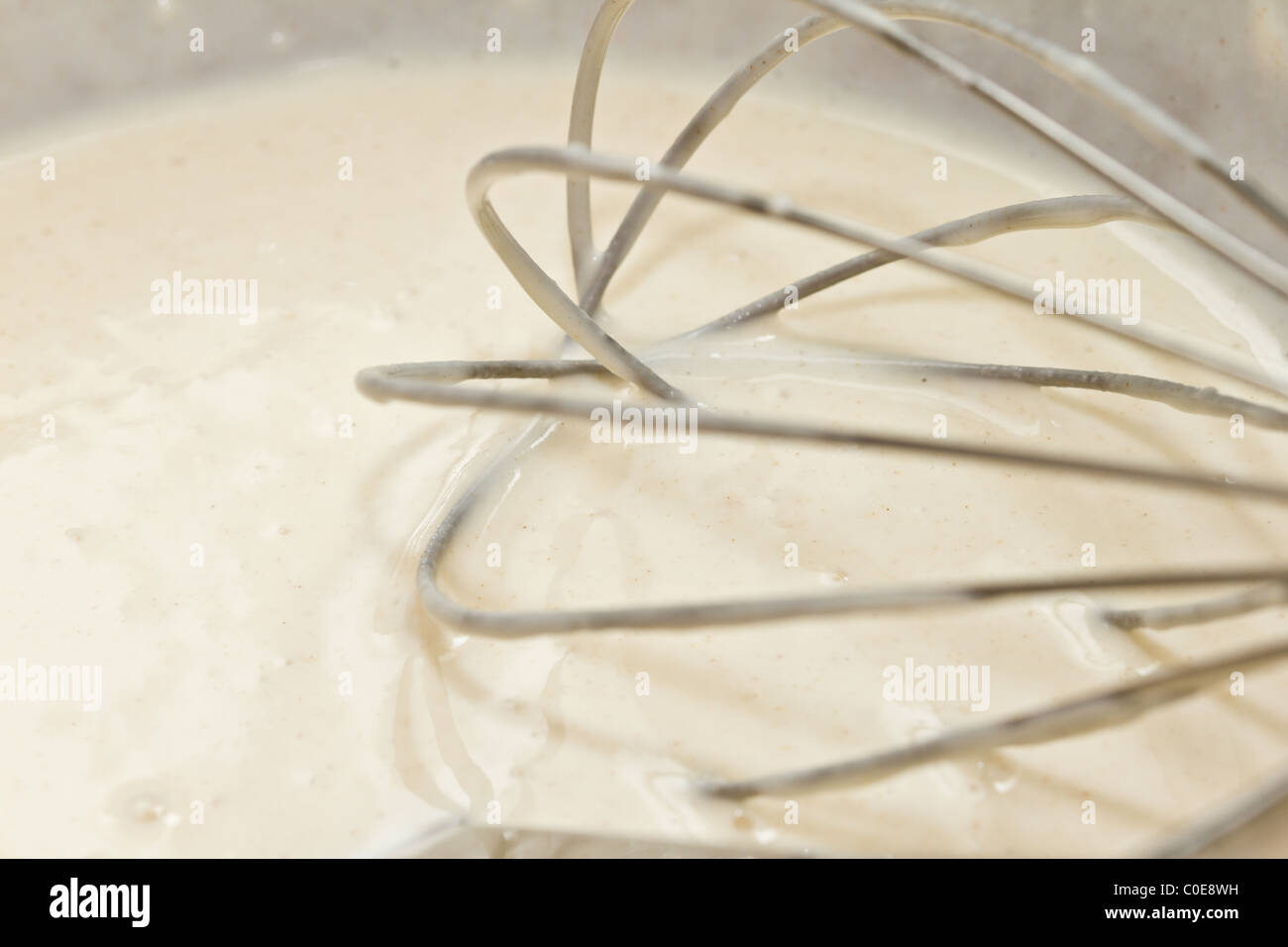 Pancake batter mix with whisk close up abstract Stock Photo - Alamy