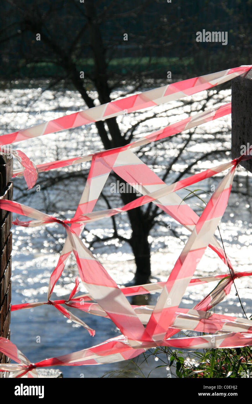 footpath to flooded river blocked with plastic red white tape Stock ...