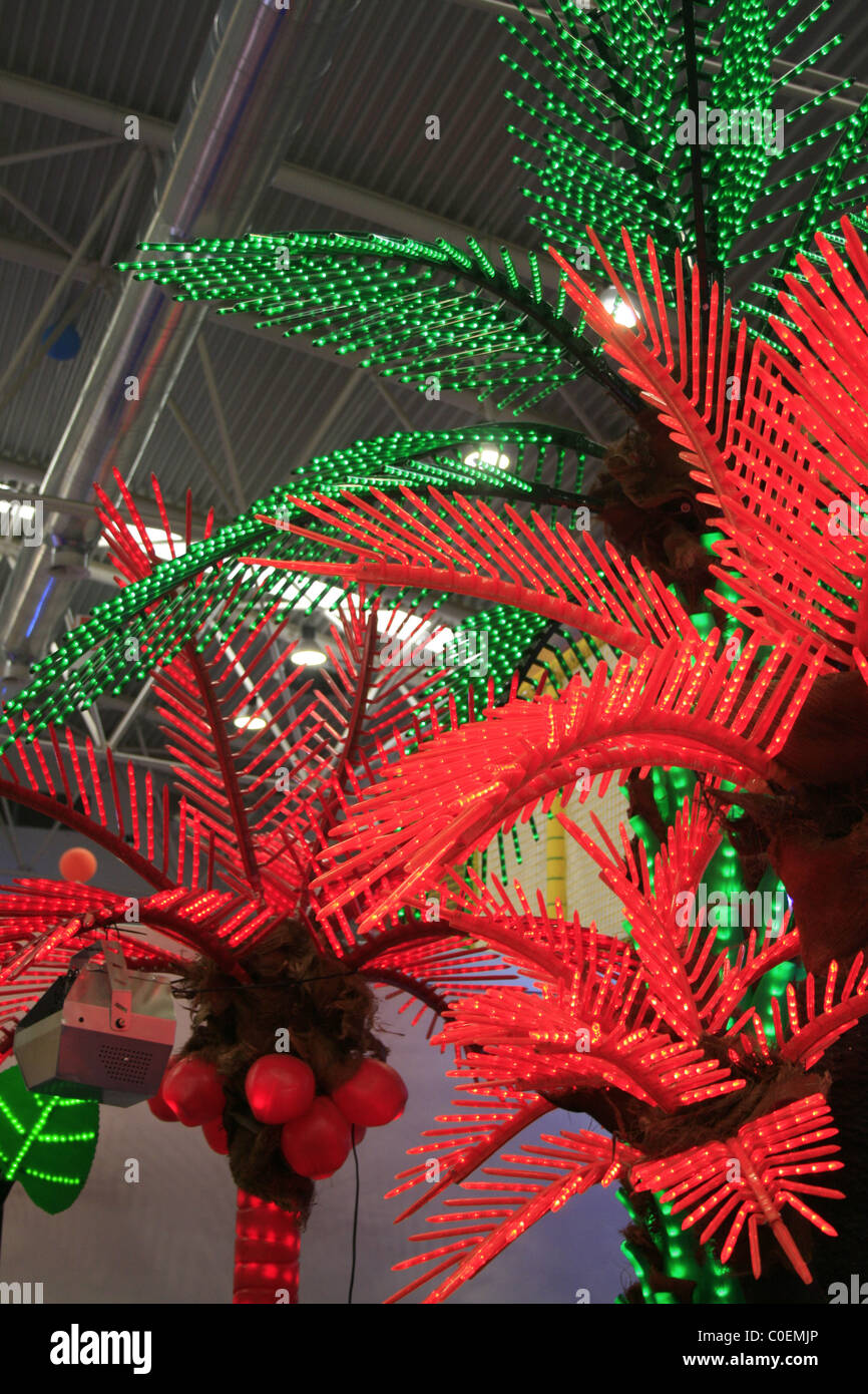 illuminated plastic palm trees at trade event show Stock Photo - Alamy