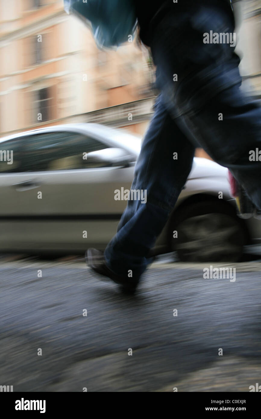 person walking in heavy rain in city town Stock Photo - Alamy