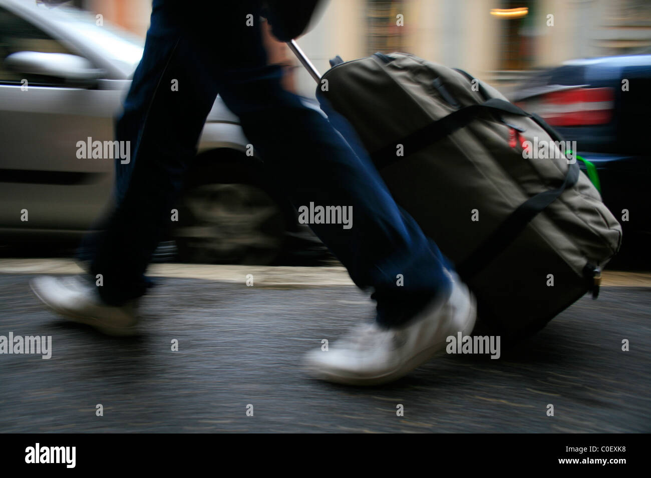 Woman pulling red trolley hi-res stock photography and images - Alamy