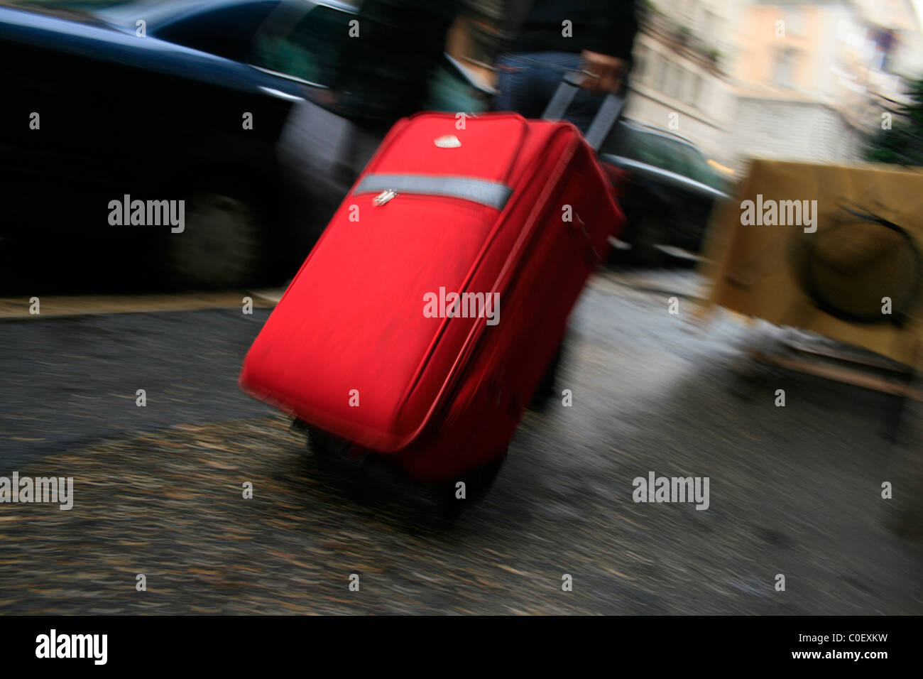 Woman pulling red trolley hi-res stock photography and images - Alamy