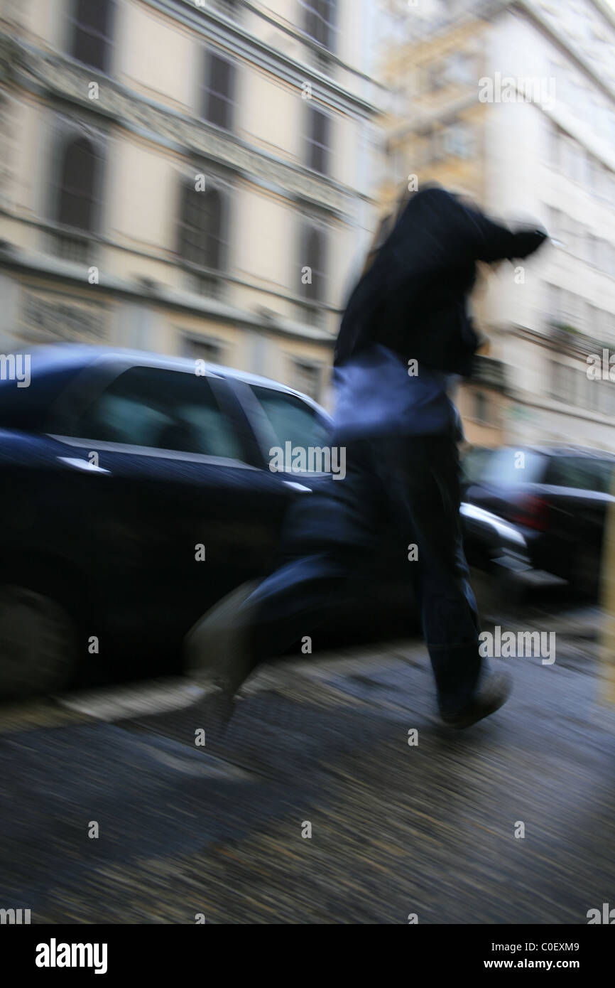 person walking in heavy rain in city town Stock Photo - Alamy
