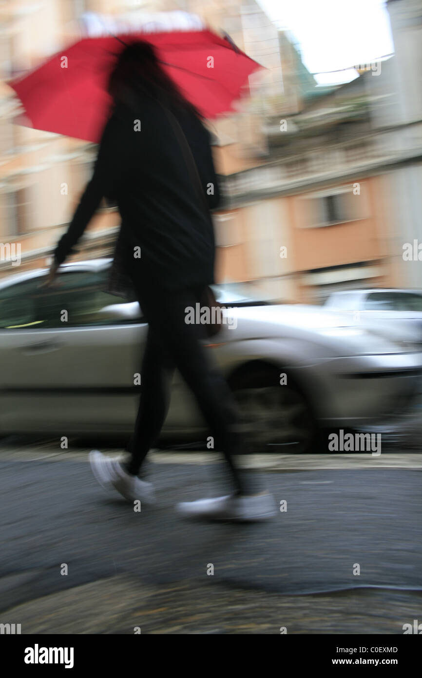 person with umbrella in heavy rain in town Stock Photo - Alamy
