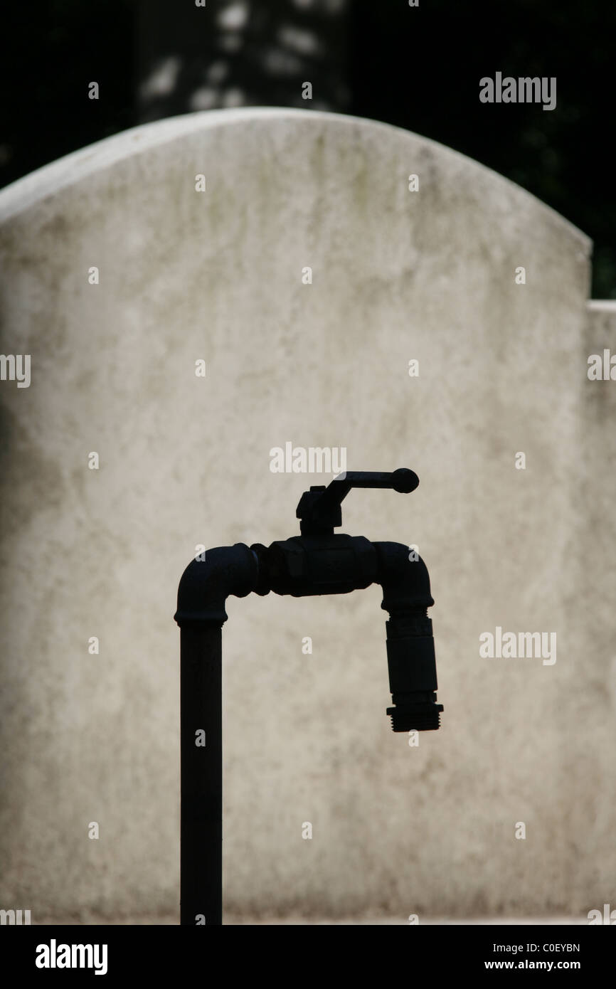 one single water tap outdoors in cemetery Stock Photo - Alamy