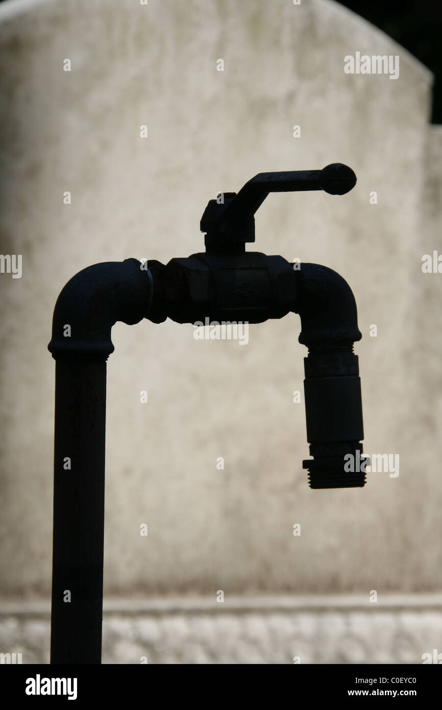 one single water tap outdoors in cemetery Stock Photo - Alamy