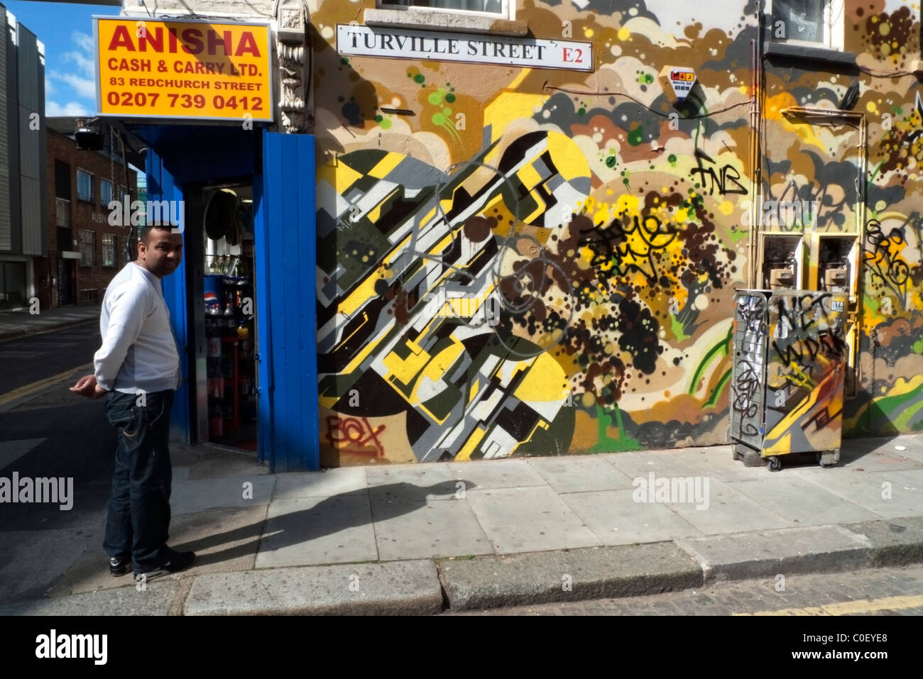 Shopkeeper outside Anisha Cash & Carry near Redchurch and Turville ...